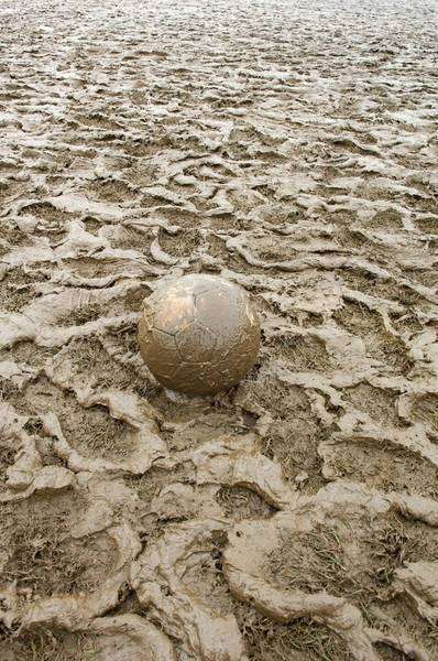 Football in muddy field - Royalty-free Stock Photo | Dissolve