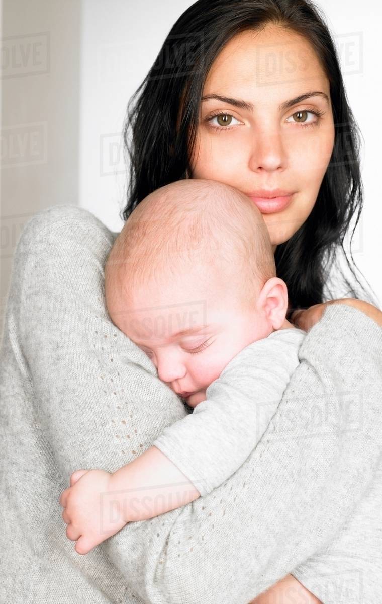 Portrait of a mother with her baby - Stock Photo - Dissolve