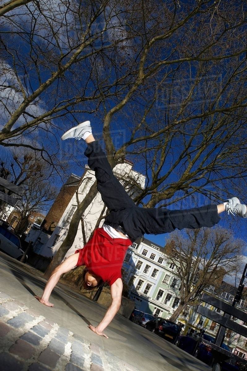 Man doing handstand in street - Royalty-free Stock Photo | Dissolve
