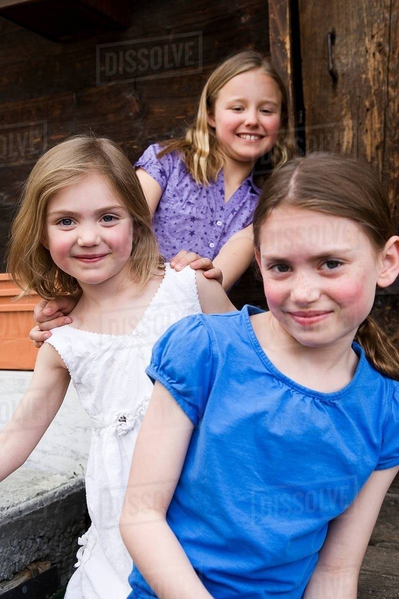 Three girls smiling. - Royalty-free Stock Photo | Dissolve