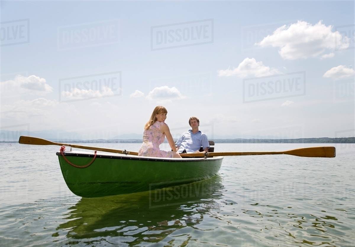 Woman and man rowing boat on lake - Royalty-free Stock Photo | Dissolve