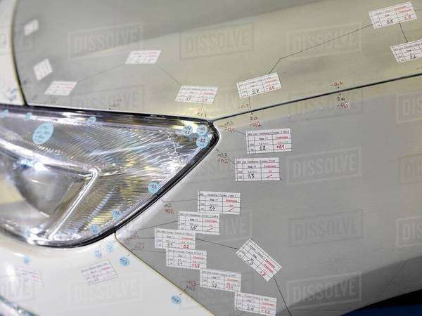 Car Headlight And Stickers In Factory - Stock Photo - Dissolve