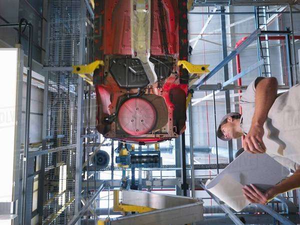 Car Plant Worker & Car From Below - Stock Photo - Dissolve