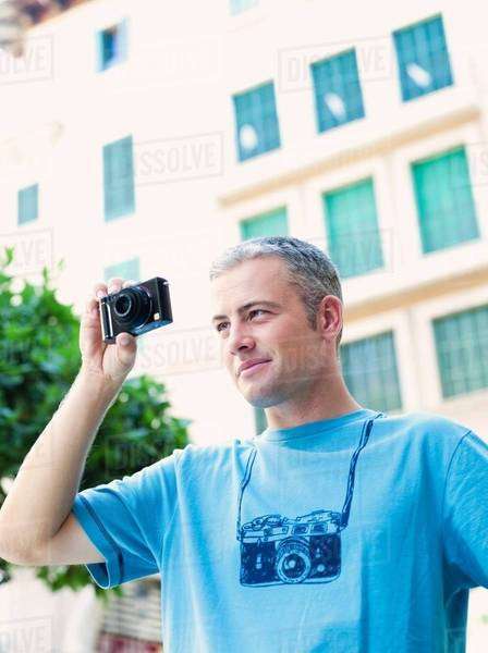 Man using camera - Royalty-free Stock Photo | Dissolve