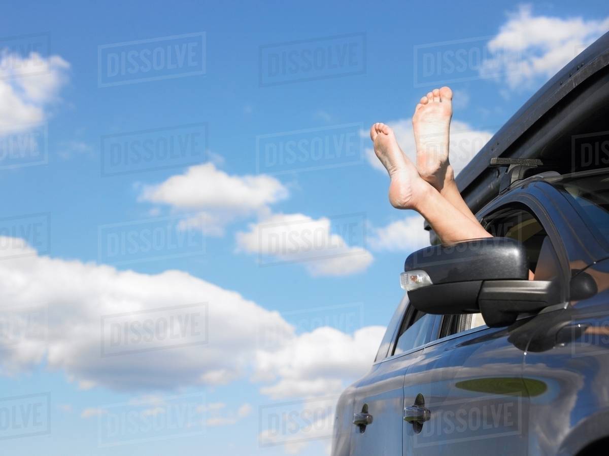 Feet out of car window - Stock Photo - Dissolve