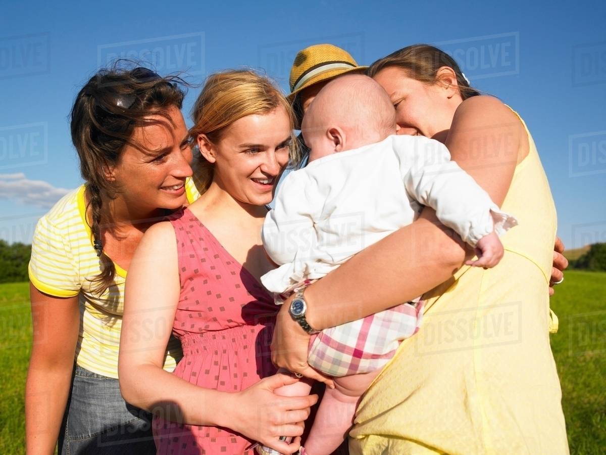 Women admiring baby - Royalty-free Stock Photo | Dissolve
