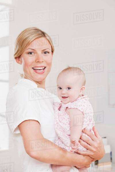 Nurse holding a baby - Stock Photo - Dissolve