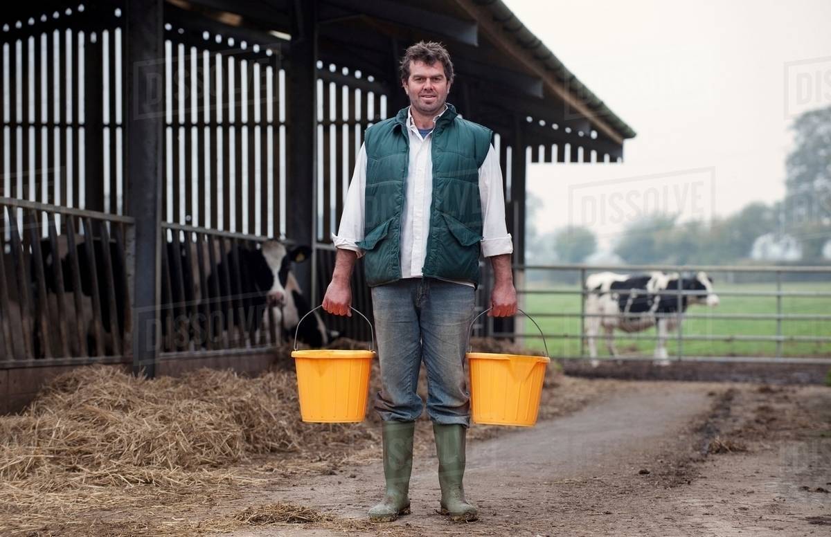 Farmer with buckets - Stock Photo - Dissolve