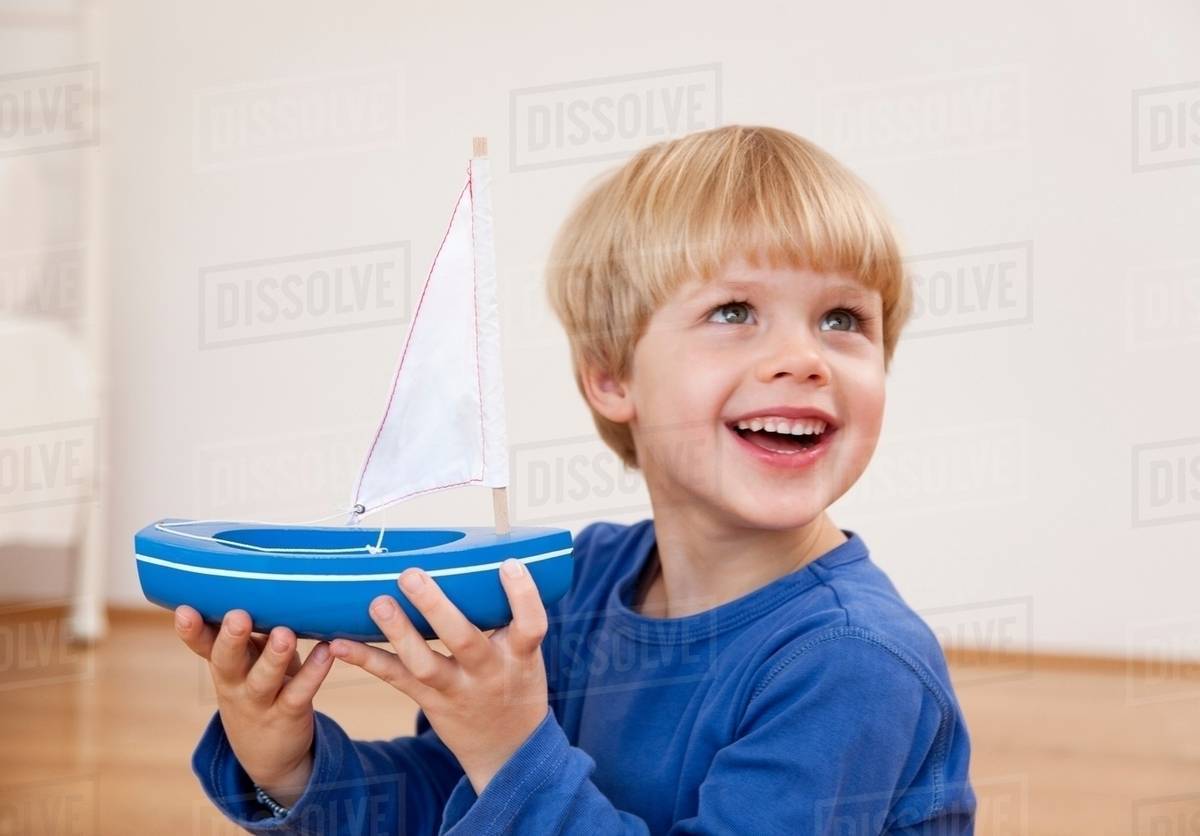 Boy with toy boat - Royalty-free Stock Photo | Dissolve