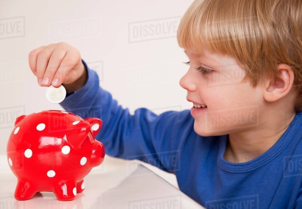 Boy saving money - Royalty-free Stock Photo | Dissolve