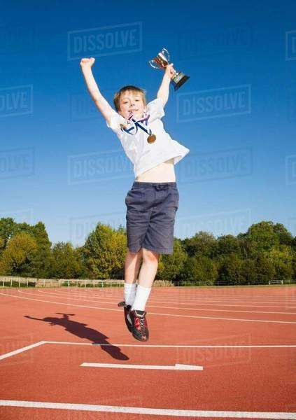 Boy with medals and trophy at Race Track - Stock Photo - Dissolve