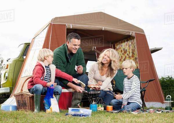 Family cooking together outdoors - Royalty-free Stock Photo | Dissolve