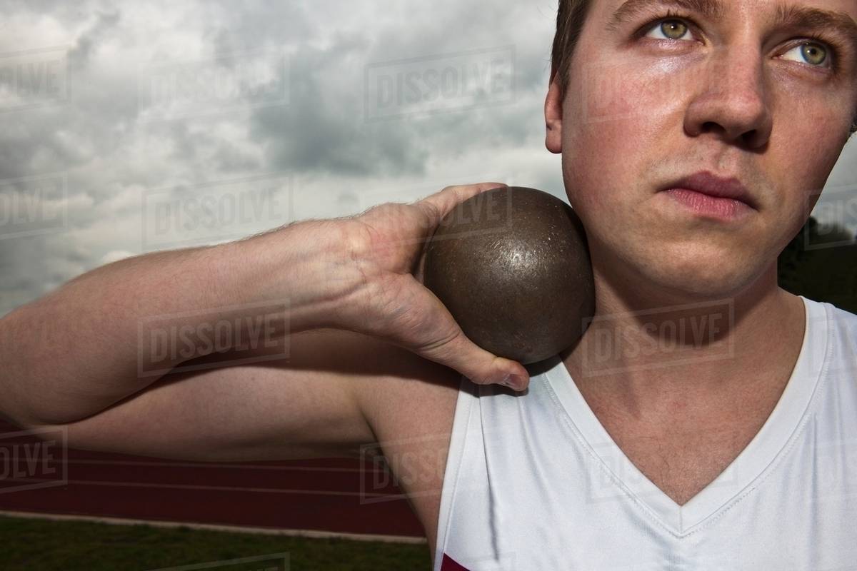 Male athlete putting shot - Stock Photo - Dissolve