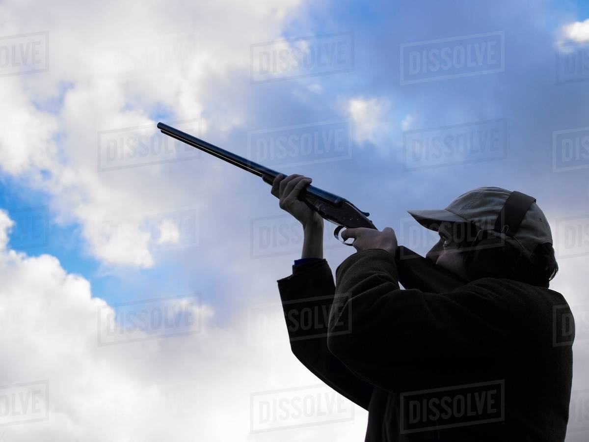Man shooting in the air - Royalty-free Stock Photo | Dissolve
