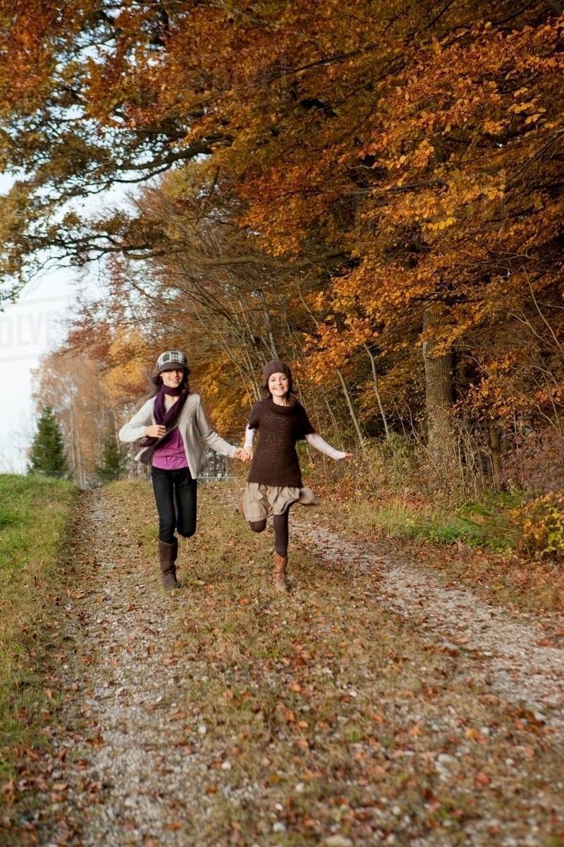 Two girls running - Royalty-free Stock Photo | Dissolve