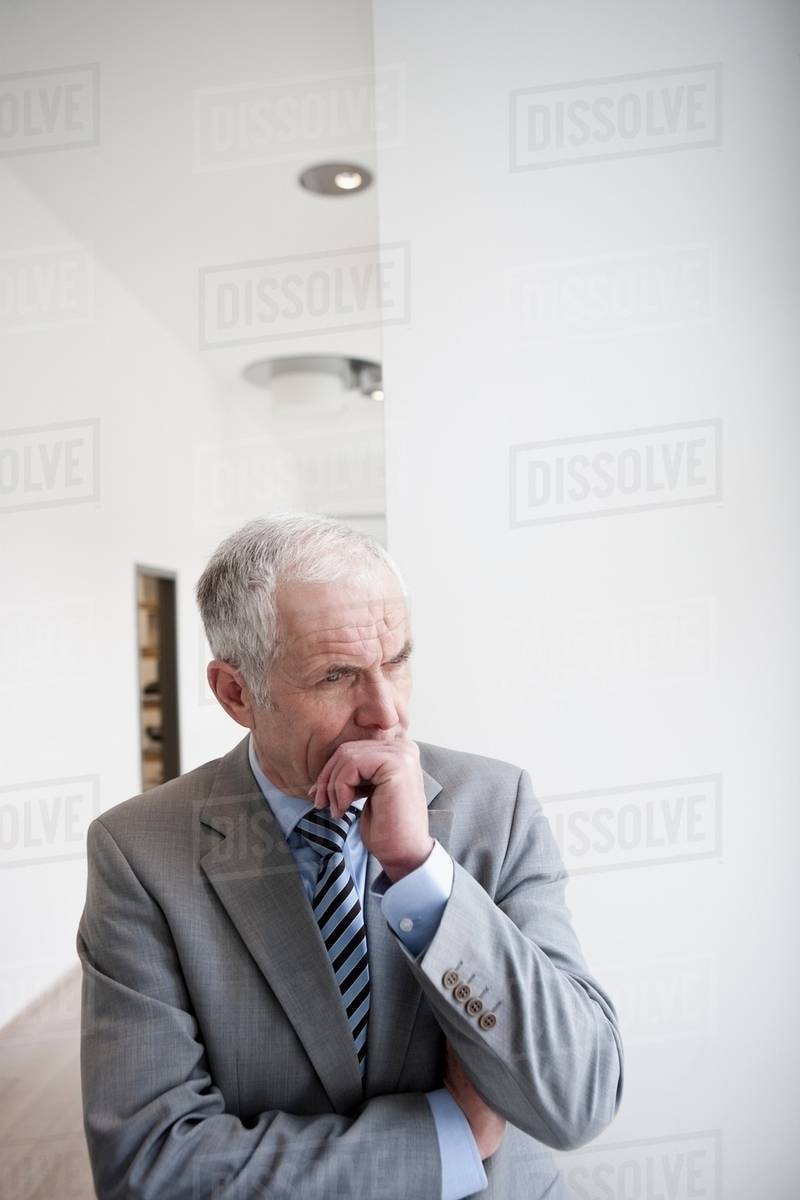 Businessman pondering - Stock Photo - Dissolve