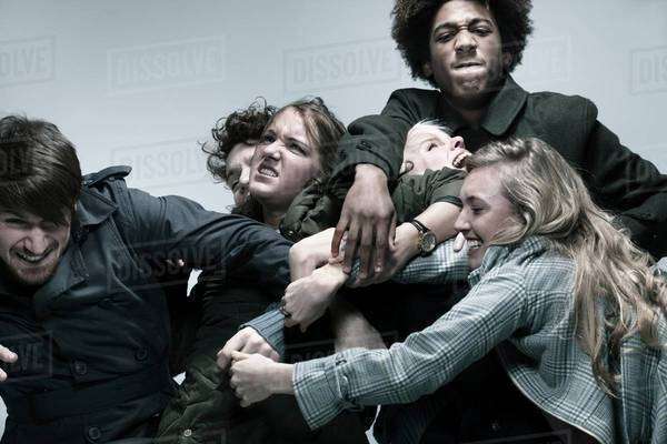 Group of adults fighting for space - Royalty-free Stock Photo | Dissolve