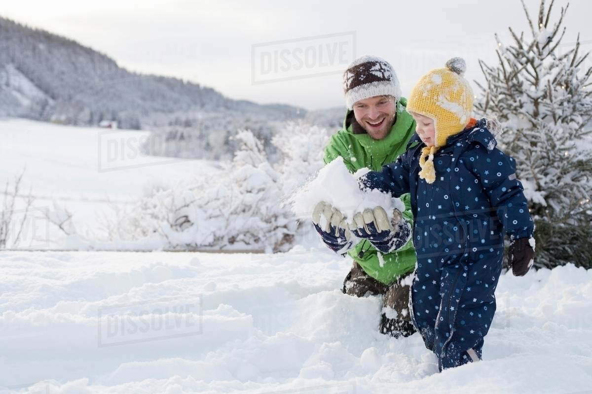 Father and son playing in the snow - Royalty-free Stock Photo | Dissolve