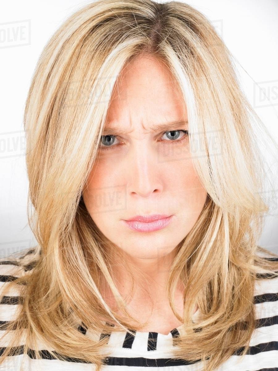Woman scowling - Stock Photo - Dissolve