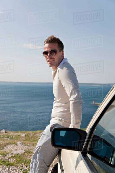 Man with oldtimer overlooking sea - Royalty-free Stock Photo | Dissolve