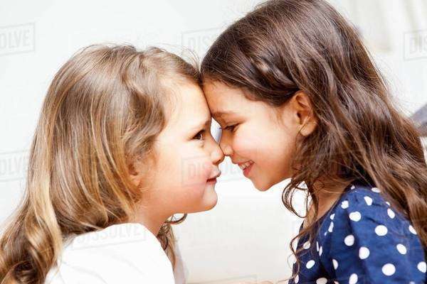 Two young girls stick together - Stock Photo - Dissolve