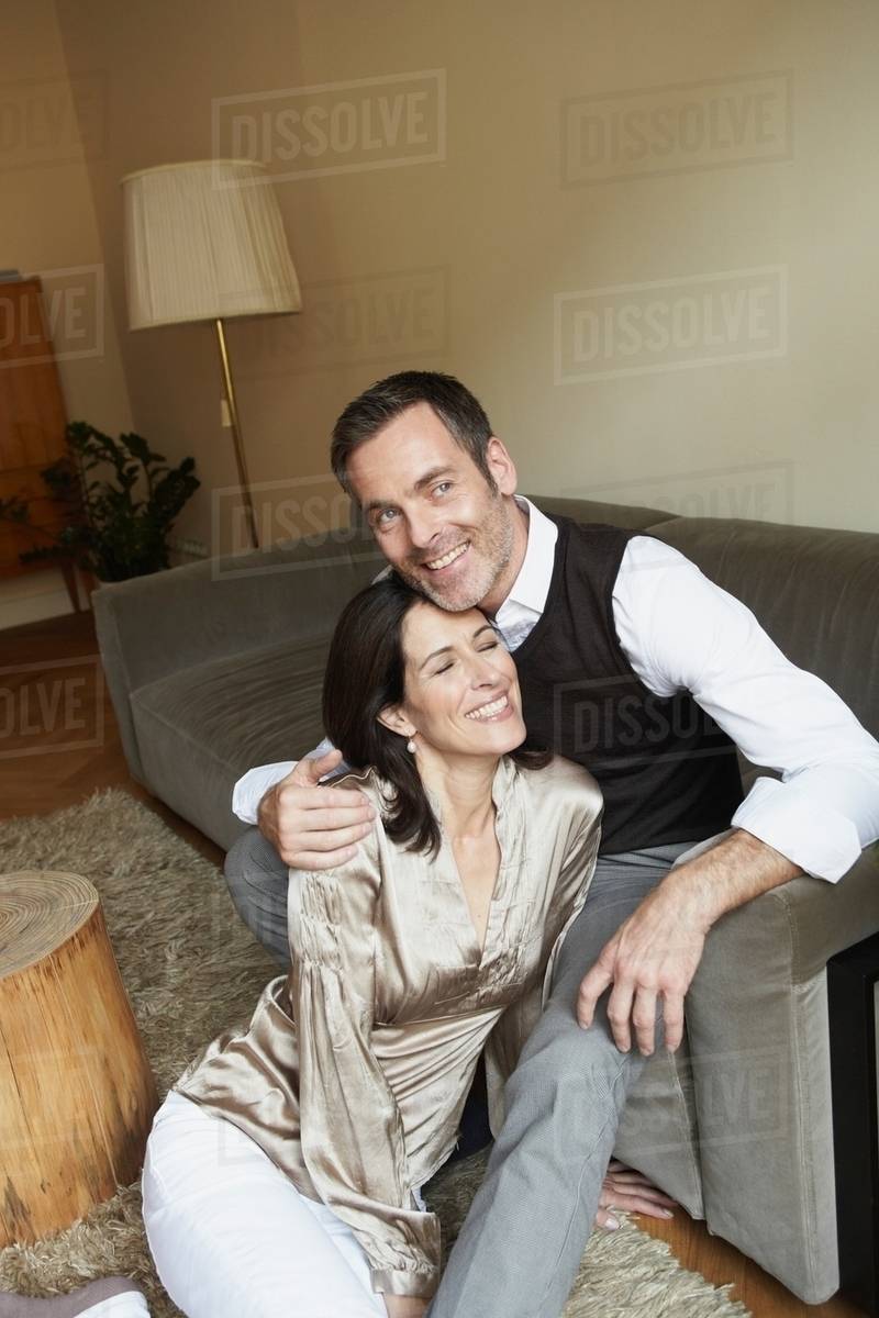 Couple snuggling on couch - Royalty-free Stock Photo | Dissolve