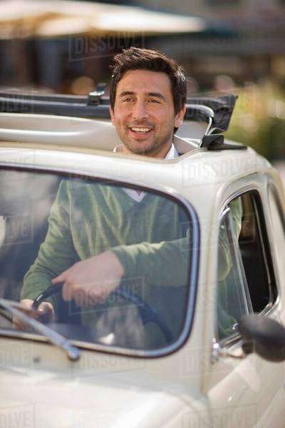 Man in car with head out of sunroof - Royalty-free Stock Photo | Dissolve