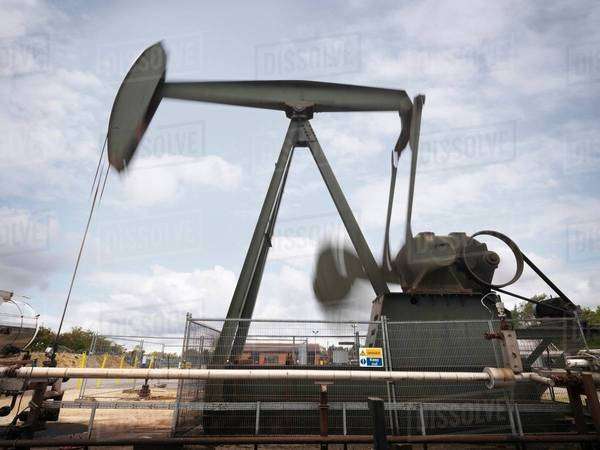 Onshore oil well pump (nodding donkey/pumpjack) with movement blur ...