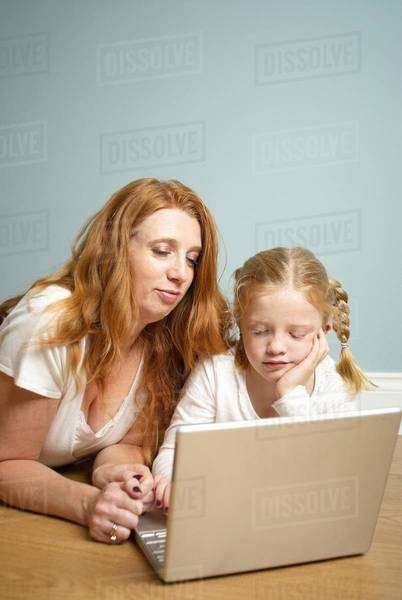 Mum and daughter on computer - Royalty-free Stock Photo | Dissolve