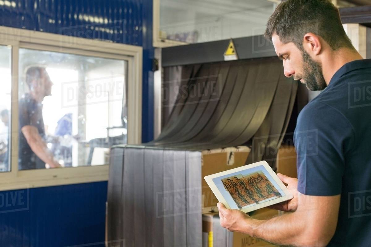 Supervisor checking xray using digital tablet in air freight warehouse ...