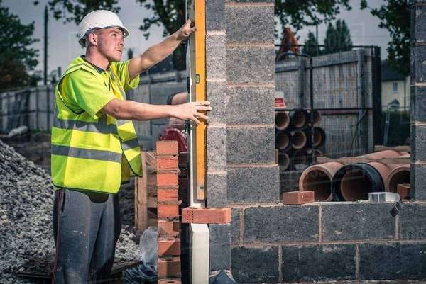 Workers laying bricks on construction site - Royalty-free Stock Photo ...