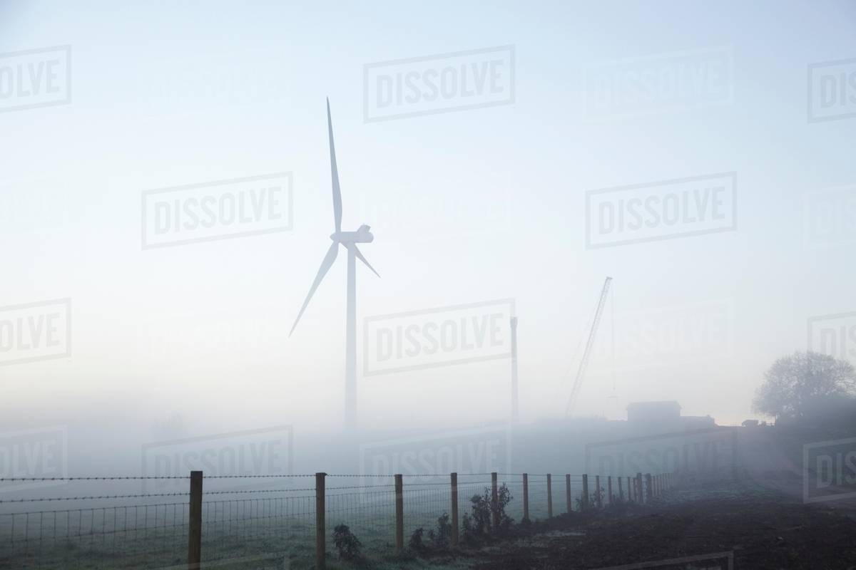 Wind turbine in mist - Stock Photo - Dissolve