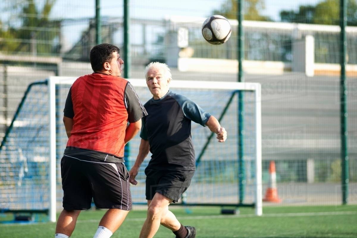 Men playing football - Royalty-free Stock Photo | Dissolve