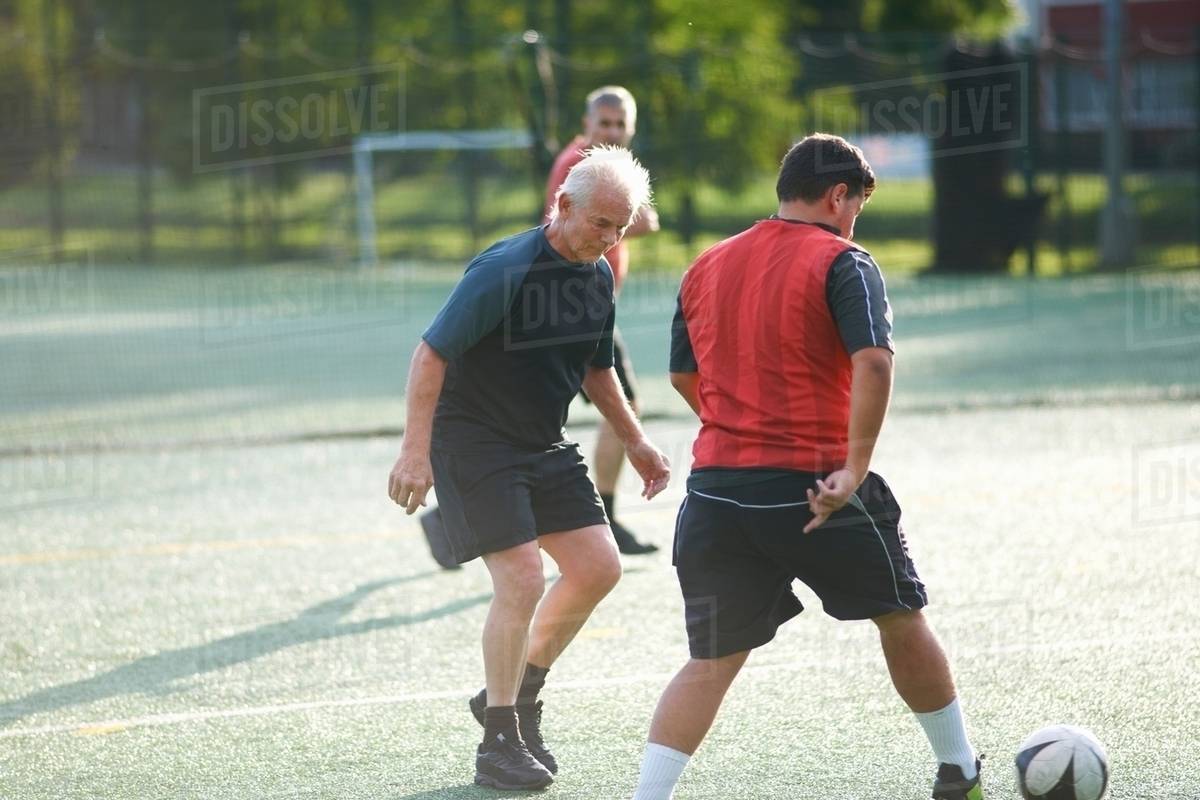 Men playing football - Stock Photo - Dissolve