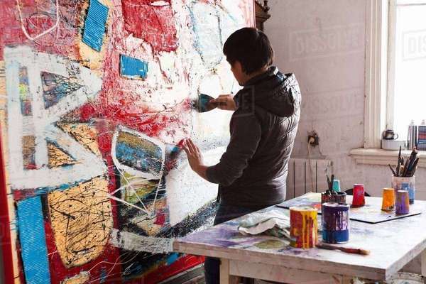 Male artist creating painted artwork - Stock Photo - Dissolve