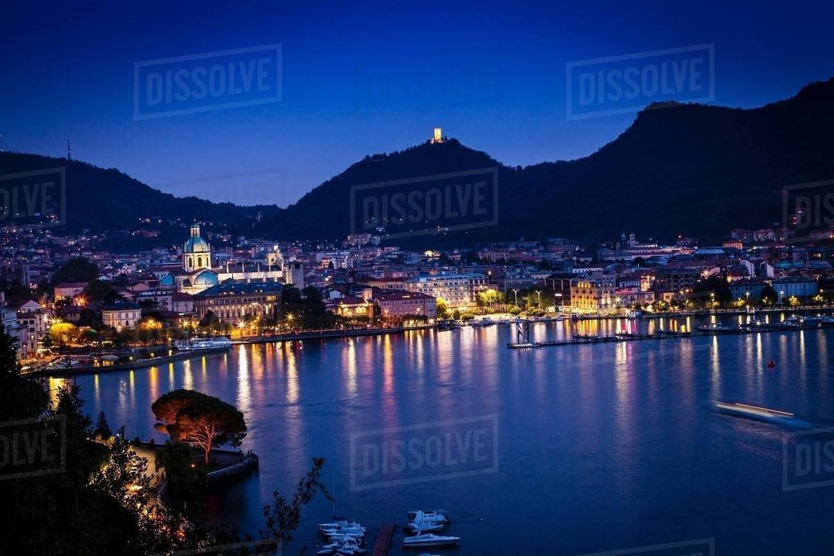 Elevated view of city lights at night on lake Como, Como, Lombardy ...
