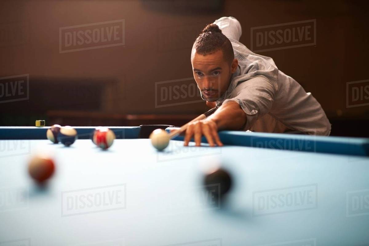 Man playing pool - Stock Photo - Dissolve