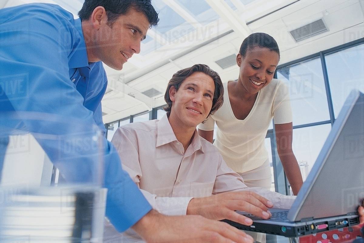 Business people using laptop - Royalty-free Stock Photo | Dissolve