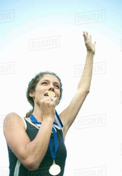 Runners celebrating with medals - Stock Photo - Dissolve