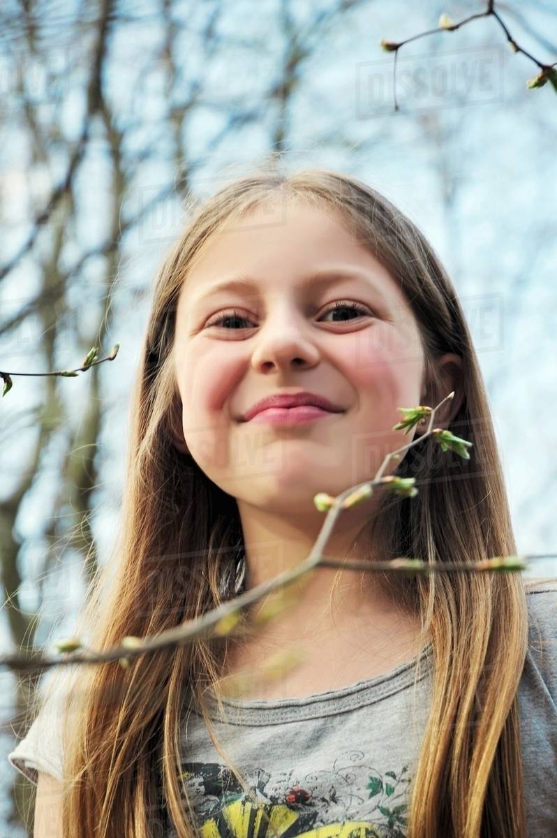 Girl smiling outdoors - Stock Photo - Dissolve