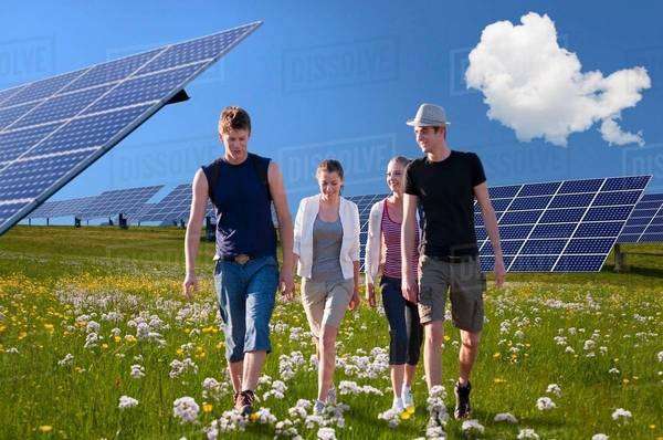 People walking by solar panels - Royalty-free Stock Photo | Dissolve