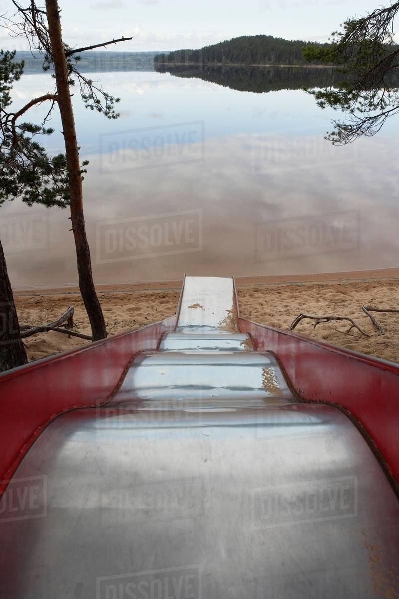 Empty slide leading into lake - Royalty-free Stock Photo | Dissolve