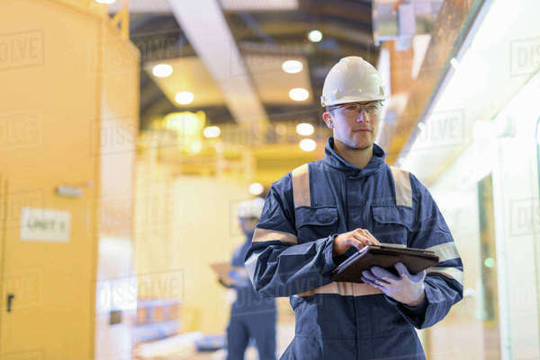 Portrait of worker in generating hall in hydroelectric power station ...