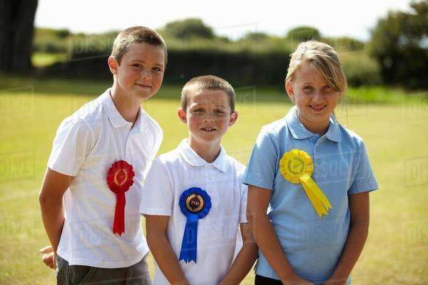 Children wearing ribbons in field - Royalty-free Stock Photo | Dissolve