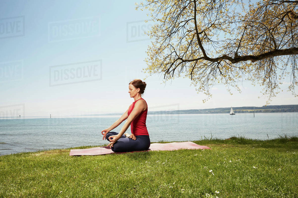 Side view of woman meditating - Royalty-free Stock Photo | Dissolve