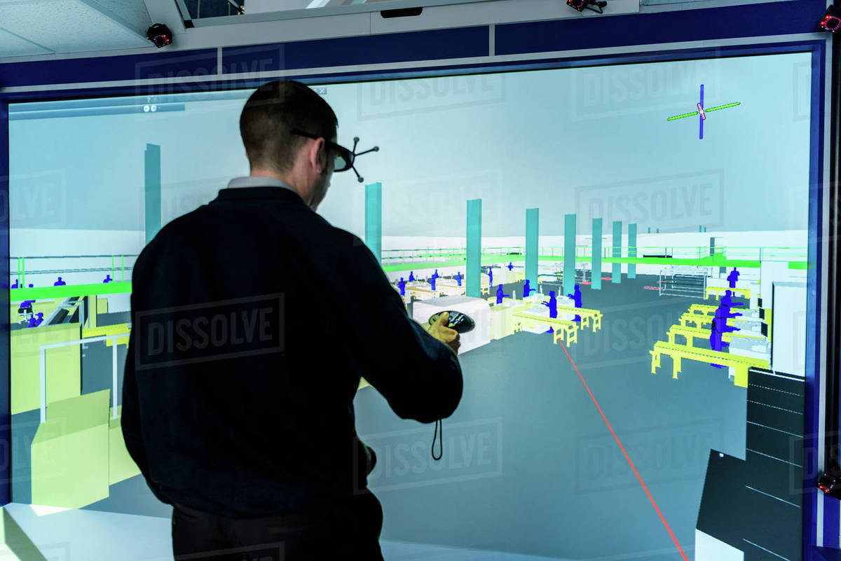 Engineer inspecting factory layout in 3D in virtual reality suite ...