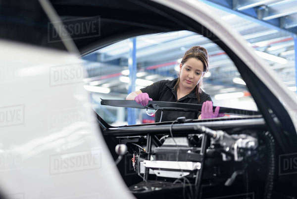 Female engineer assembles car in racing car factory - Stock Photo ...