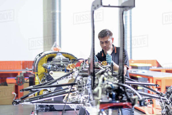 Engineer with car under construction in racing car factory - Stock ...