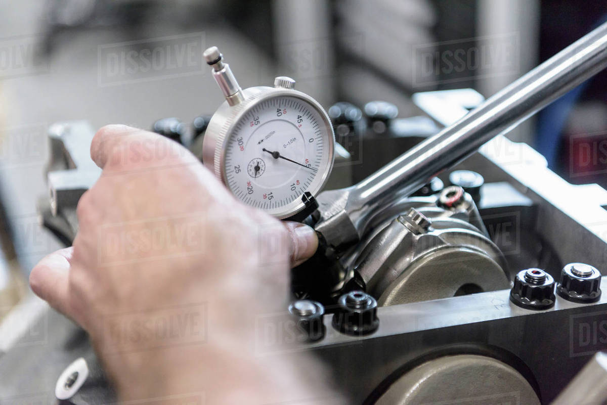 Engineer assembling engine in racing car factory, close up - Stock ...