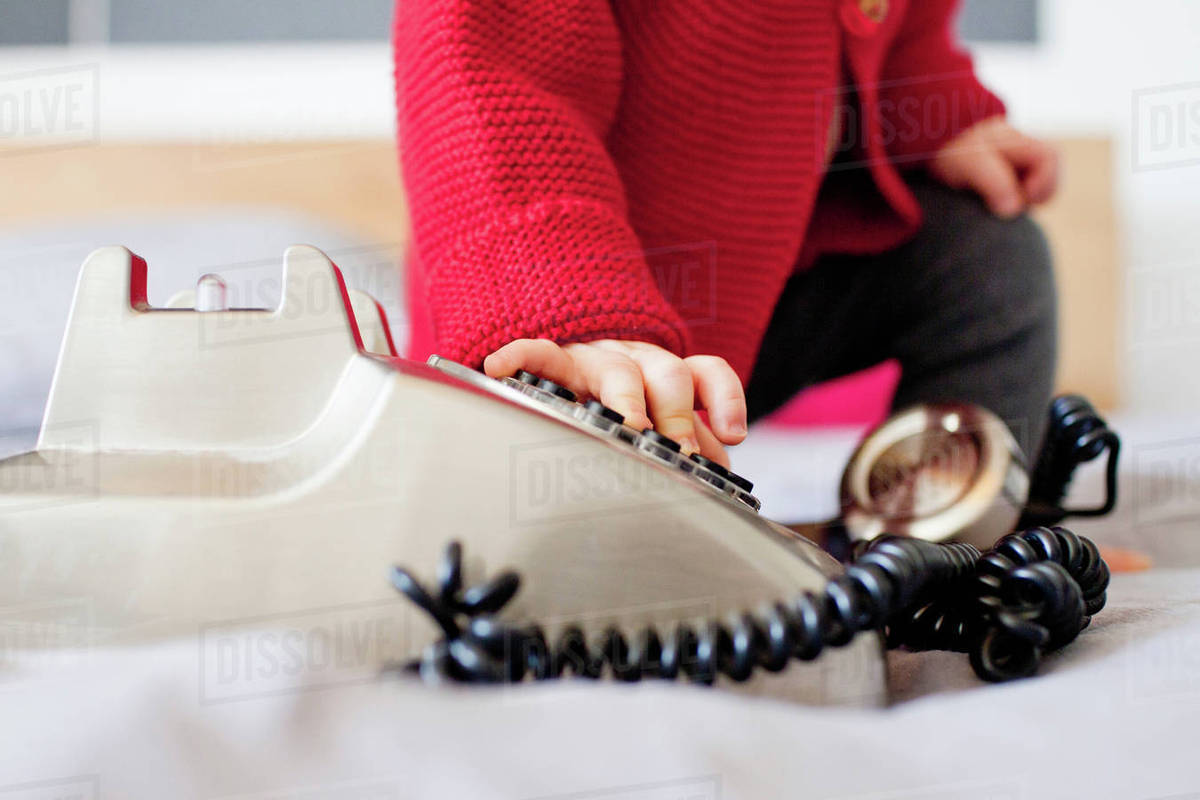 Cropped shot of baby girl dialling landline telephone - Royalty-free ...